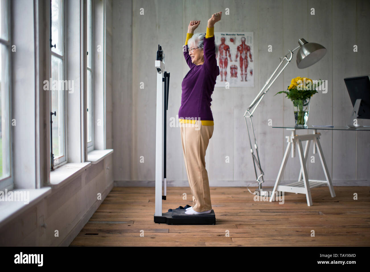 Elderly woman celebrates after stepping on the scales Stock Photo - Alamy