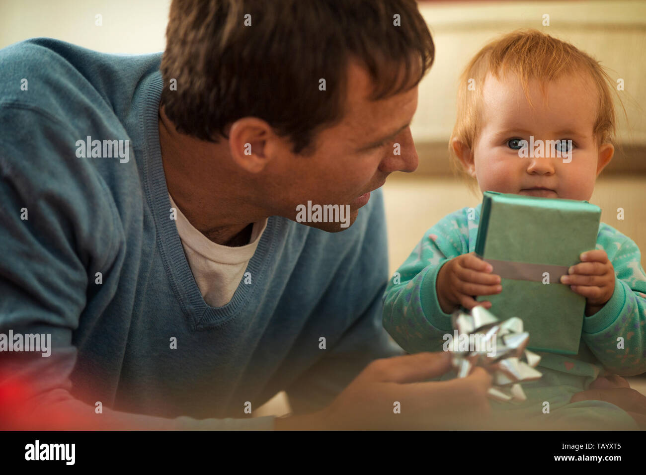 Happy father opening presents with his baby daughter Stock Photo - Alamy