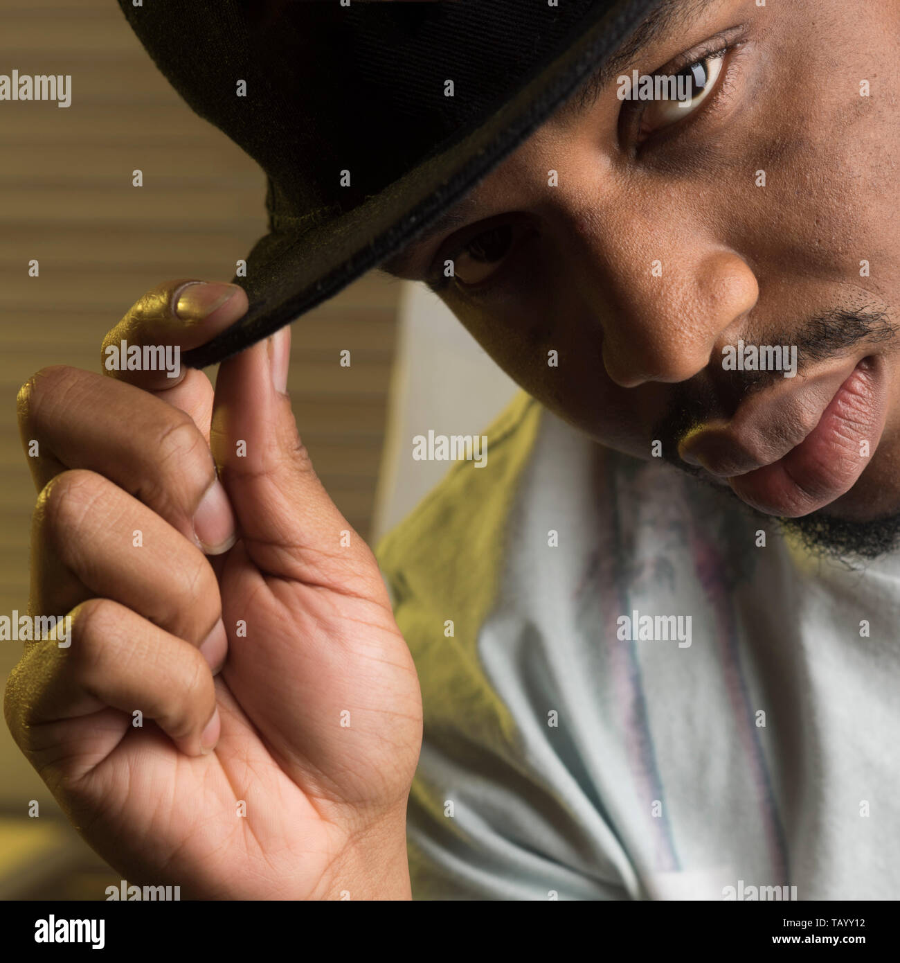 Rapper culture concept. Black macho with beard wears rapper cap and ...