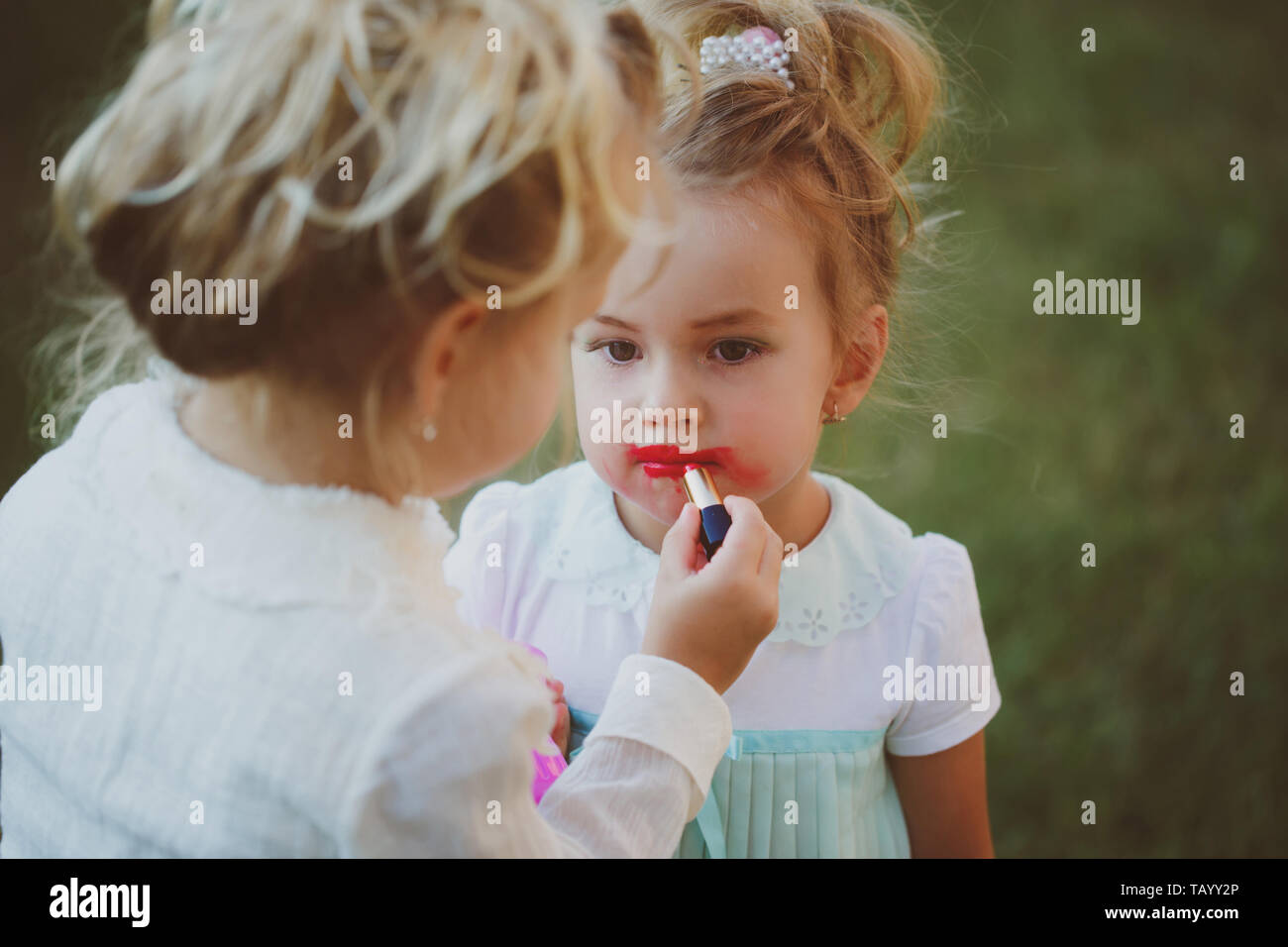 Beauty, look, fashion. Baby apply red lipstick on lips of kid model ...