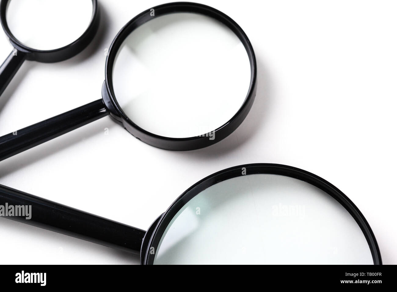Three magnifiers over white Stock Photo - Alamy
