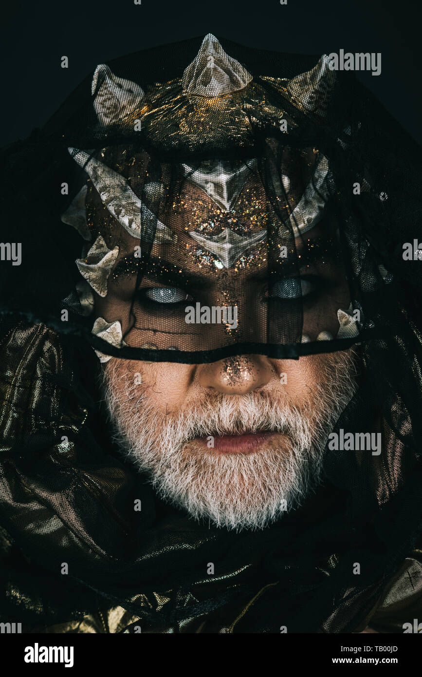 Demon with golden skin and thorns covering his eyes with dark veil ...