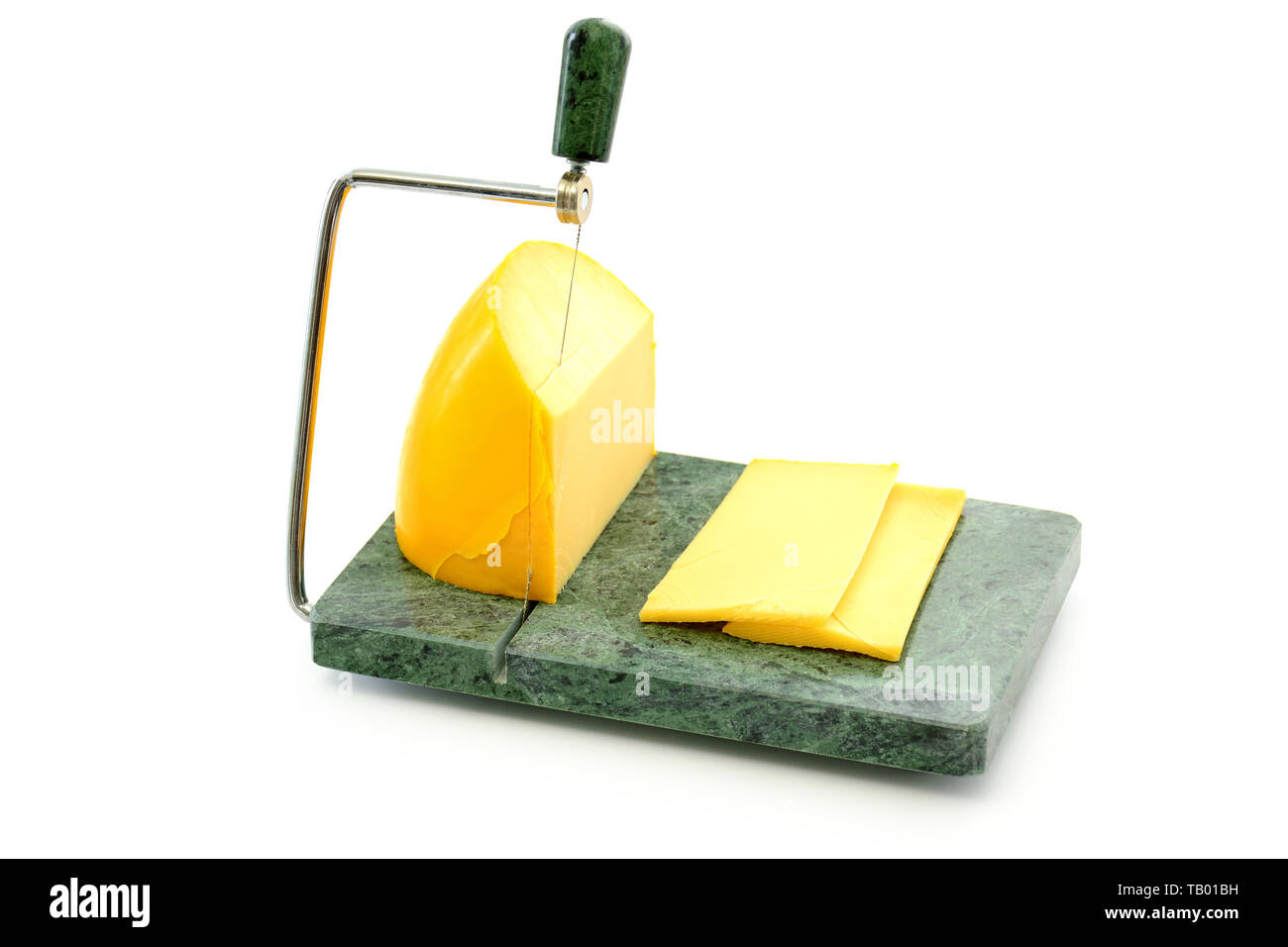 Wedge of Gouda cheese and slices on jade wire cheese slicer on white ...
