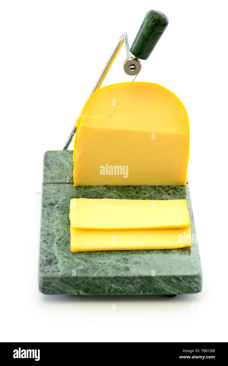 Wedge of Gouda cheese and slices on jade wire cheese slicer on white ...