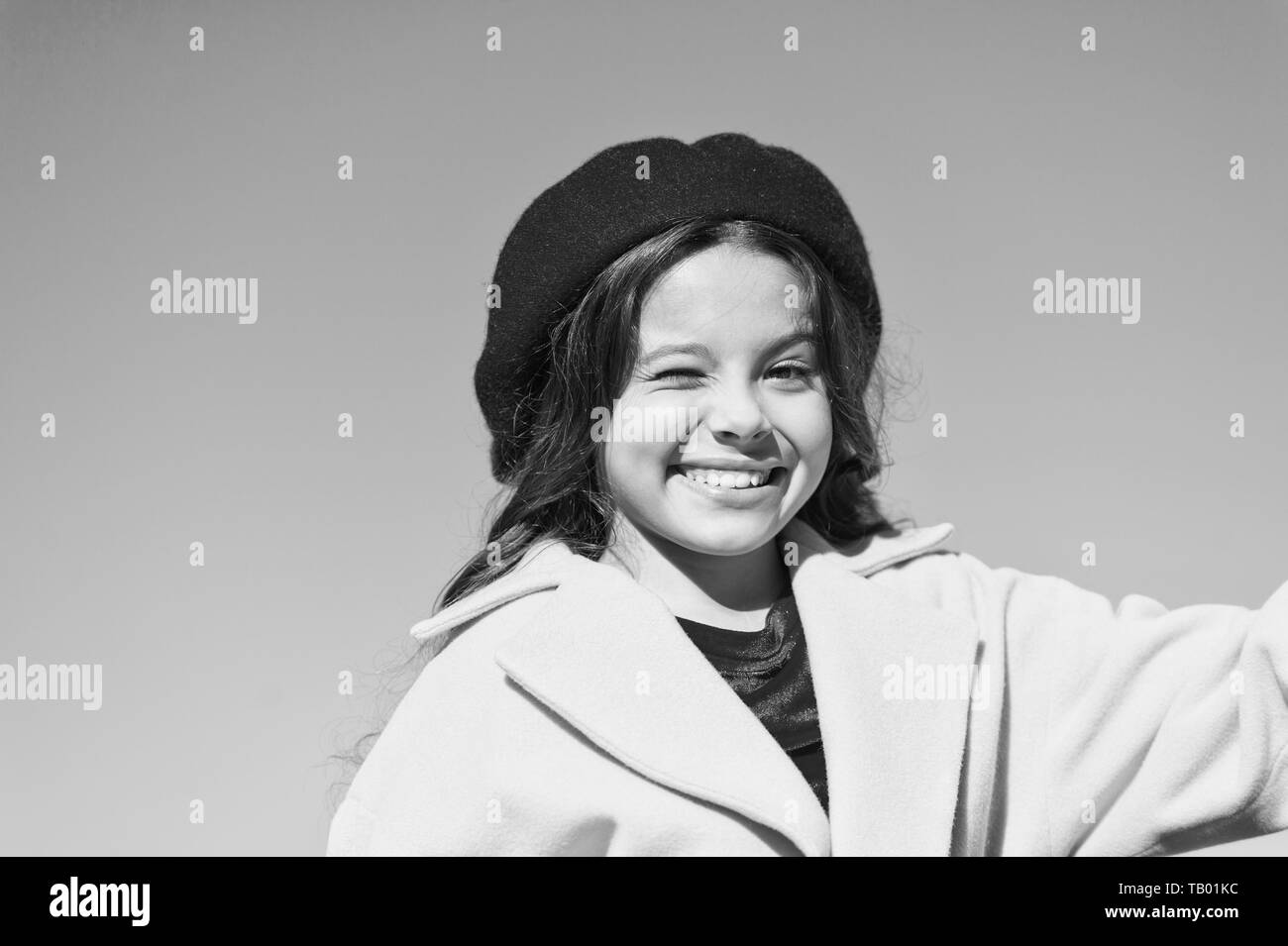 Things gonna be alright. Girl wink cheerful face blue sky background ...