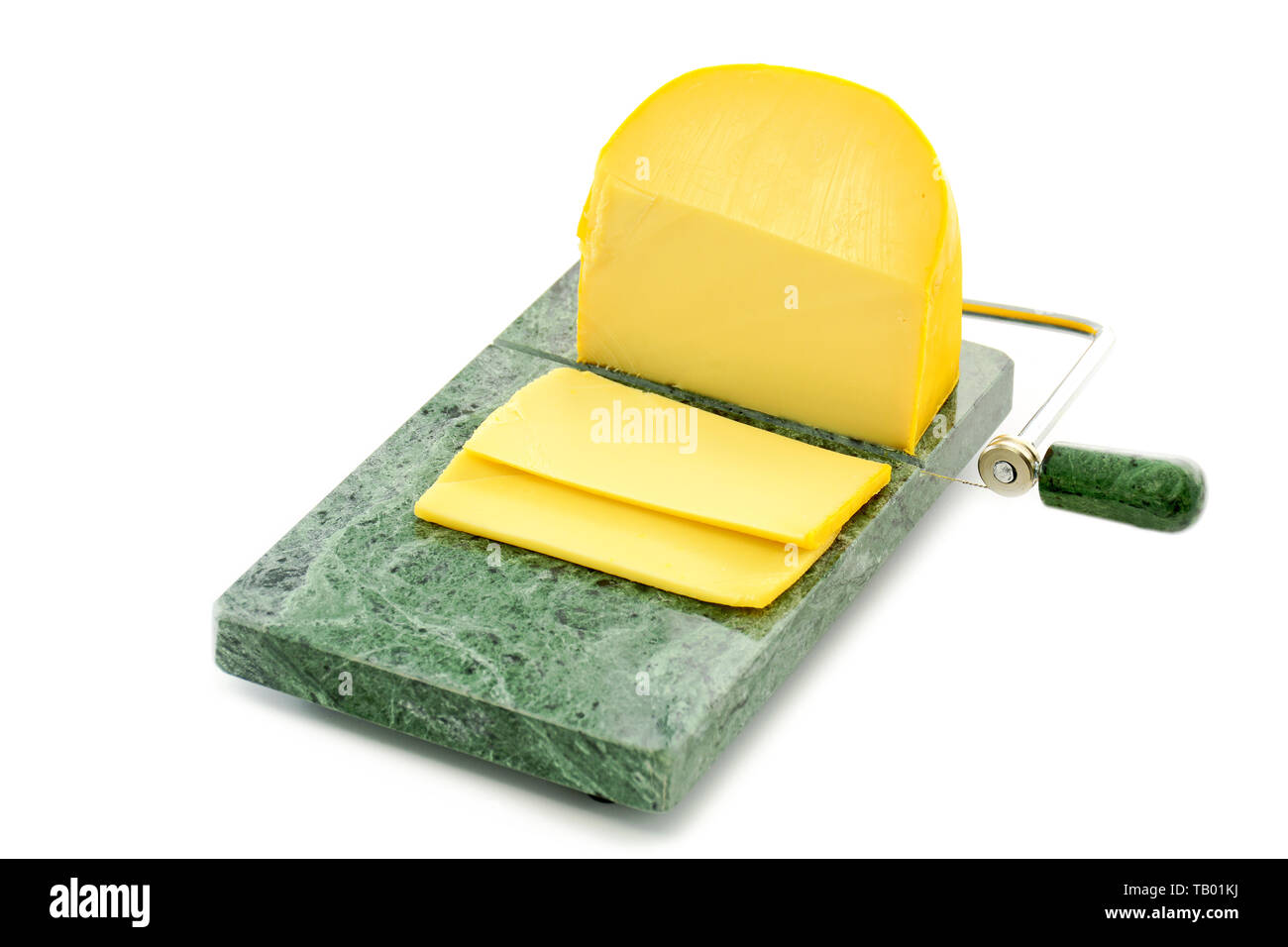 Wedge of Gouda cheese and slices on jade wire cheese slicer on white ...
