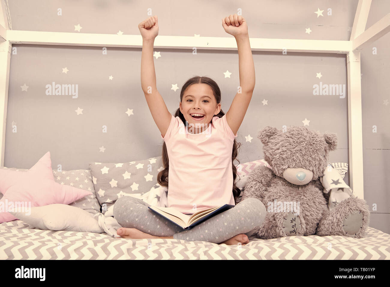 Finished reading book. Girl child sit bed with teddy bear finished ...