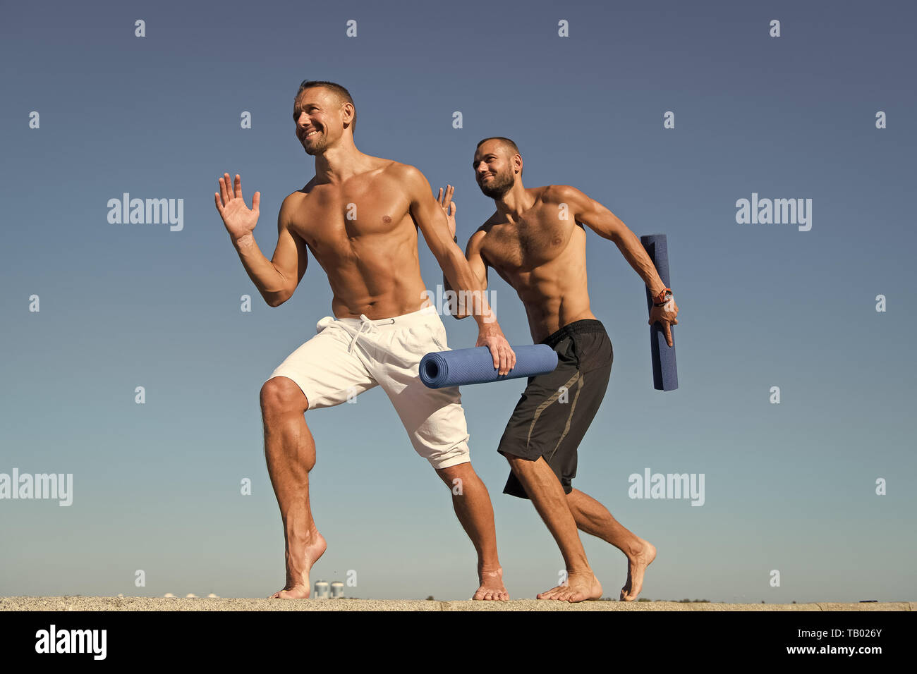 Enhancing the benefit of health activities. Muscular men do sport. Men ...