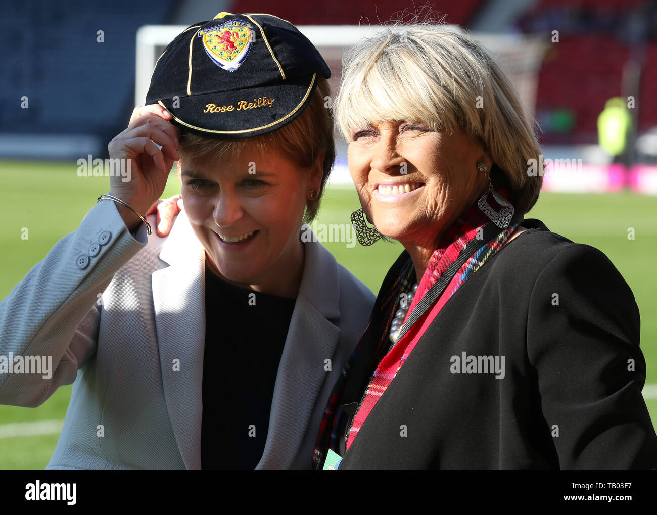Scotlands First Minister Nicola Sturgeon wears the cap belonging to ...