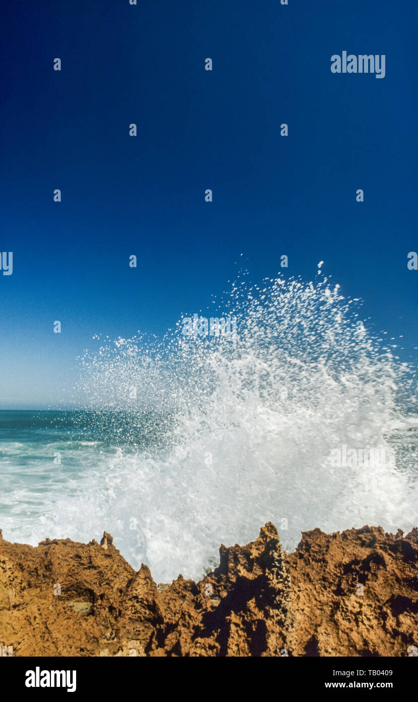 Large wave exploding over rocky shoreline Stock Photo - Alamy