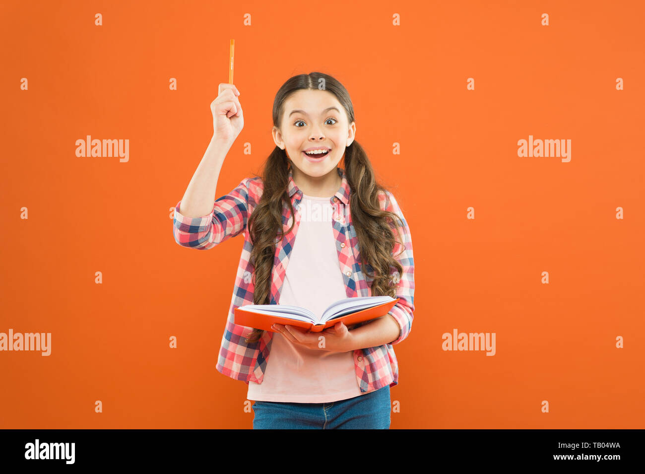 That book has given me several ideas. Little girl writing down her idea ...