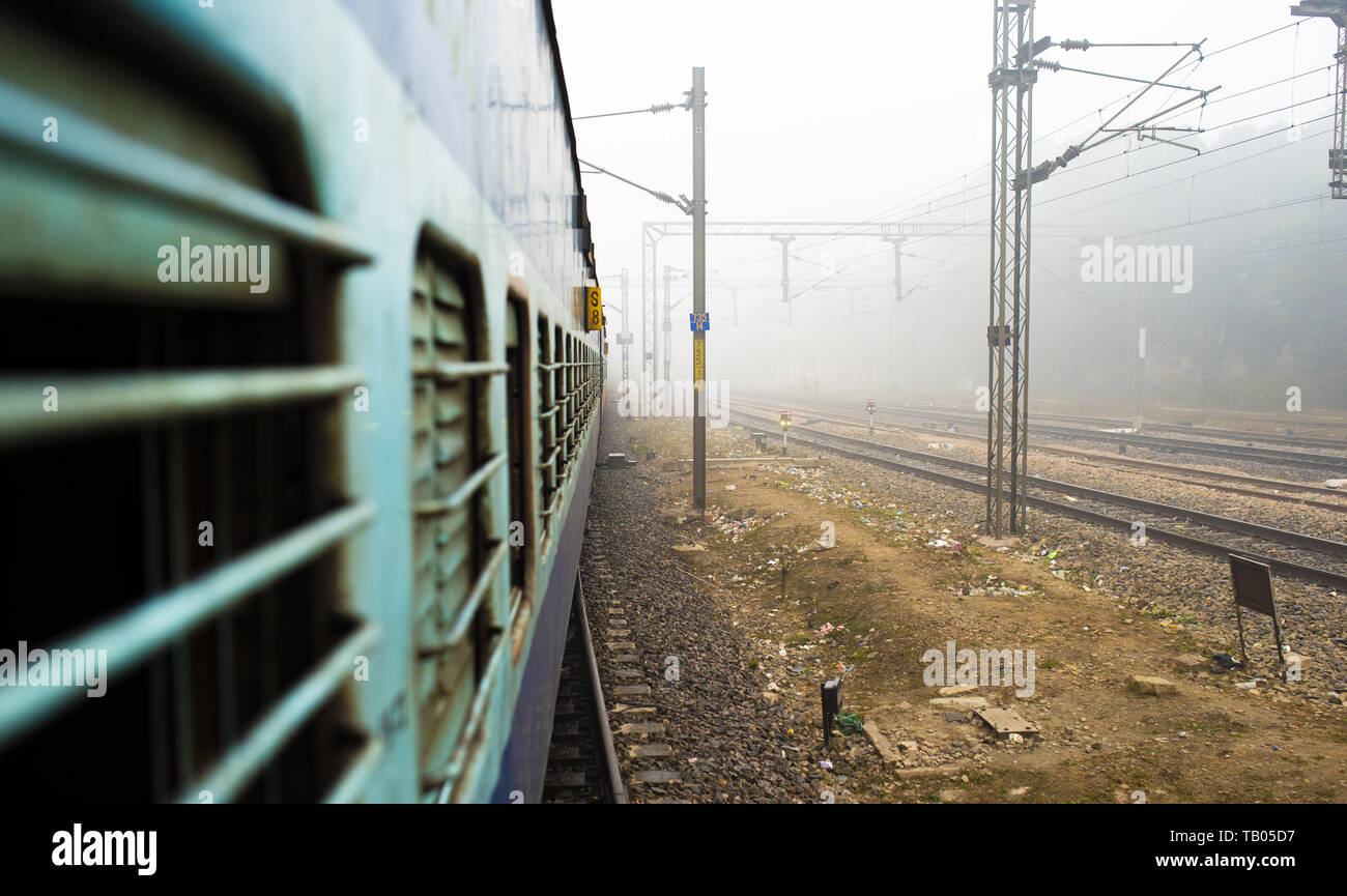 View through the window train in the polluted city of New Delhi, India ...