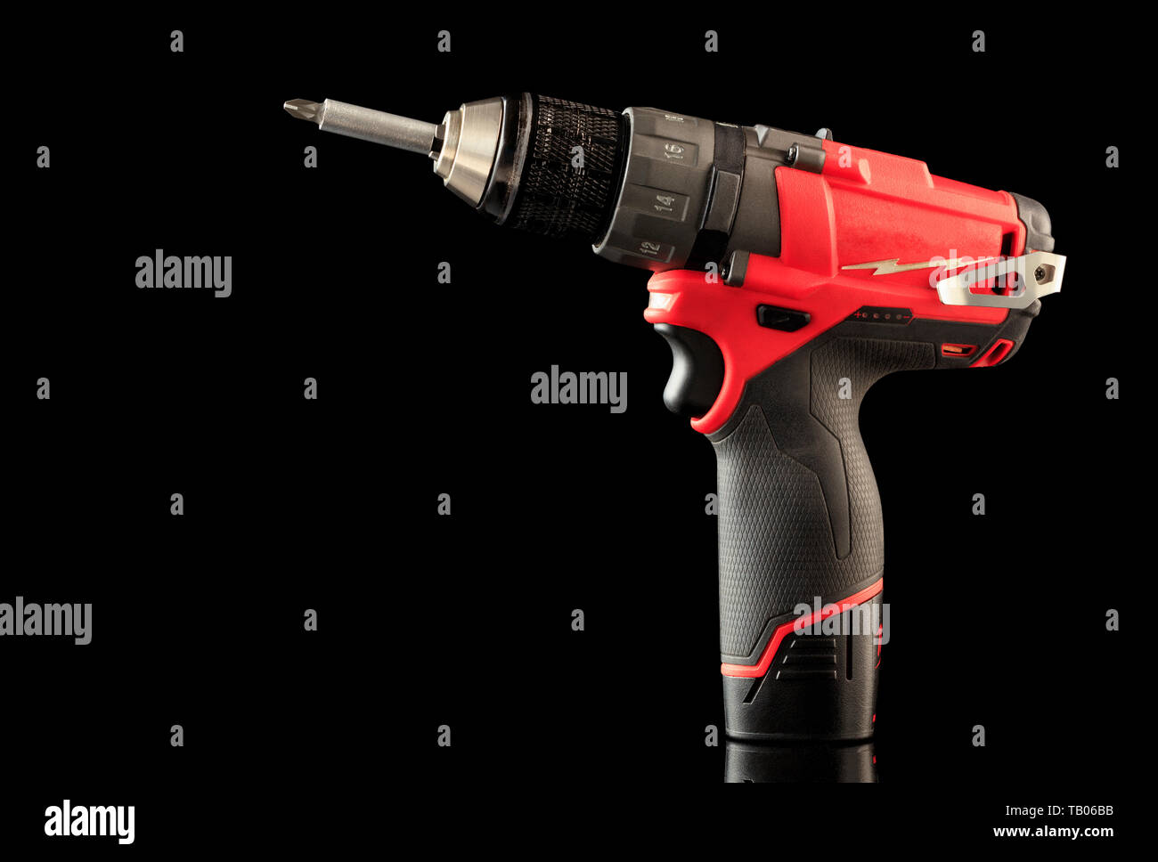 Cordless drill driver in red with rubberized handle in profile ...