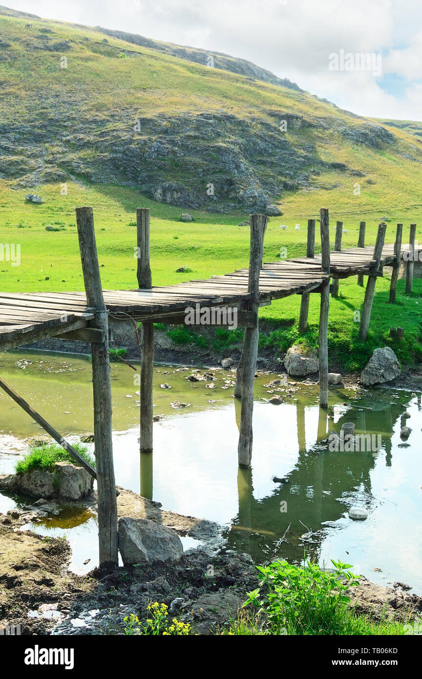 old wooden bridge over river Stock Photo - Alamy