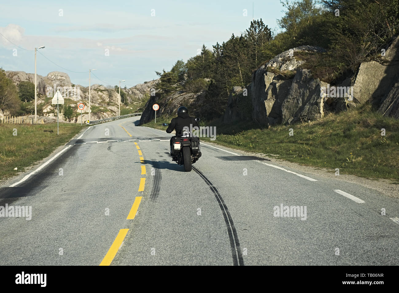 back view of two motorcyclists on mountain road in Norway Stock Photo ...