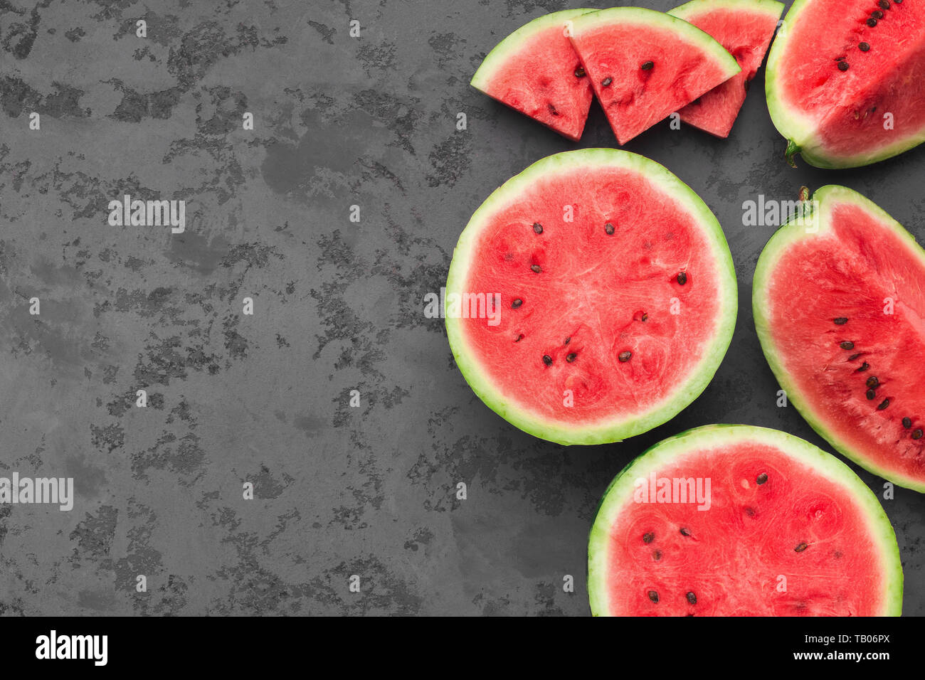 Cut fresh juicy watermelon on dark grey table Stock Photo - Alamy