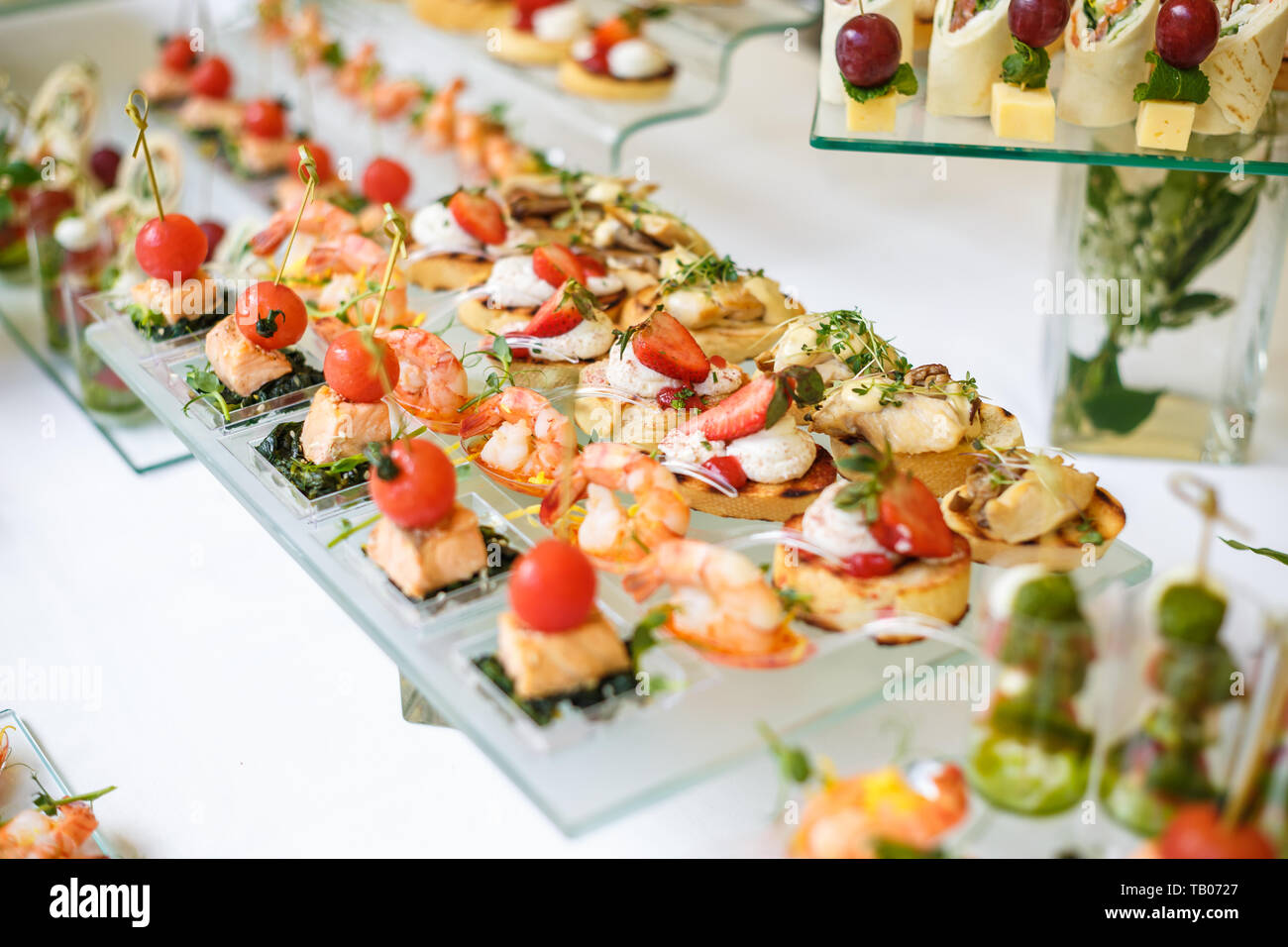 Catering. Off-site food. Buffet table with various canapes, sandwiches ...