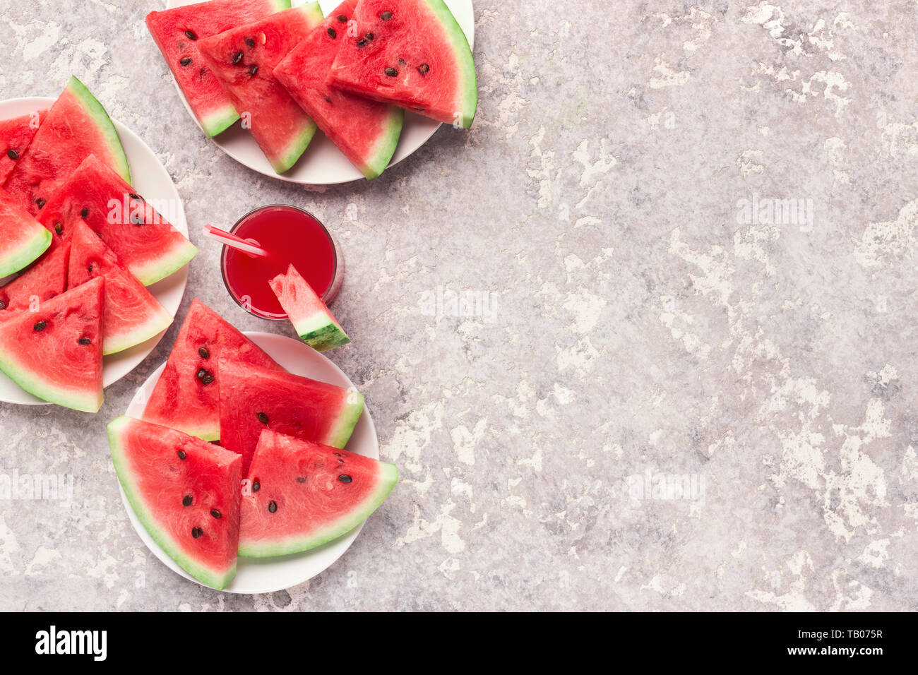 Watermelon slices and juice on grey background, top view Stock Photo ...