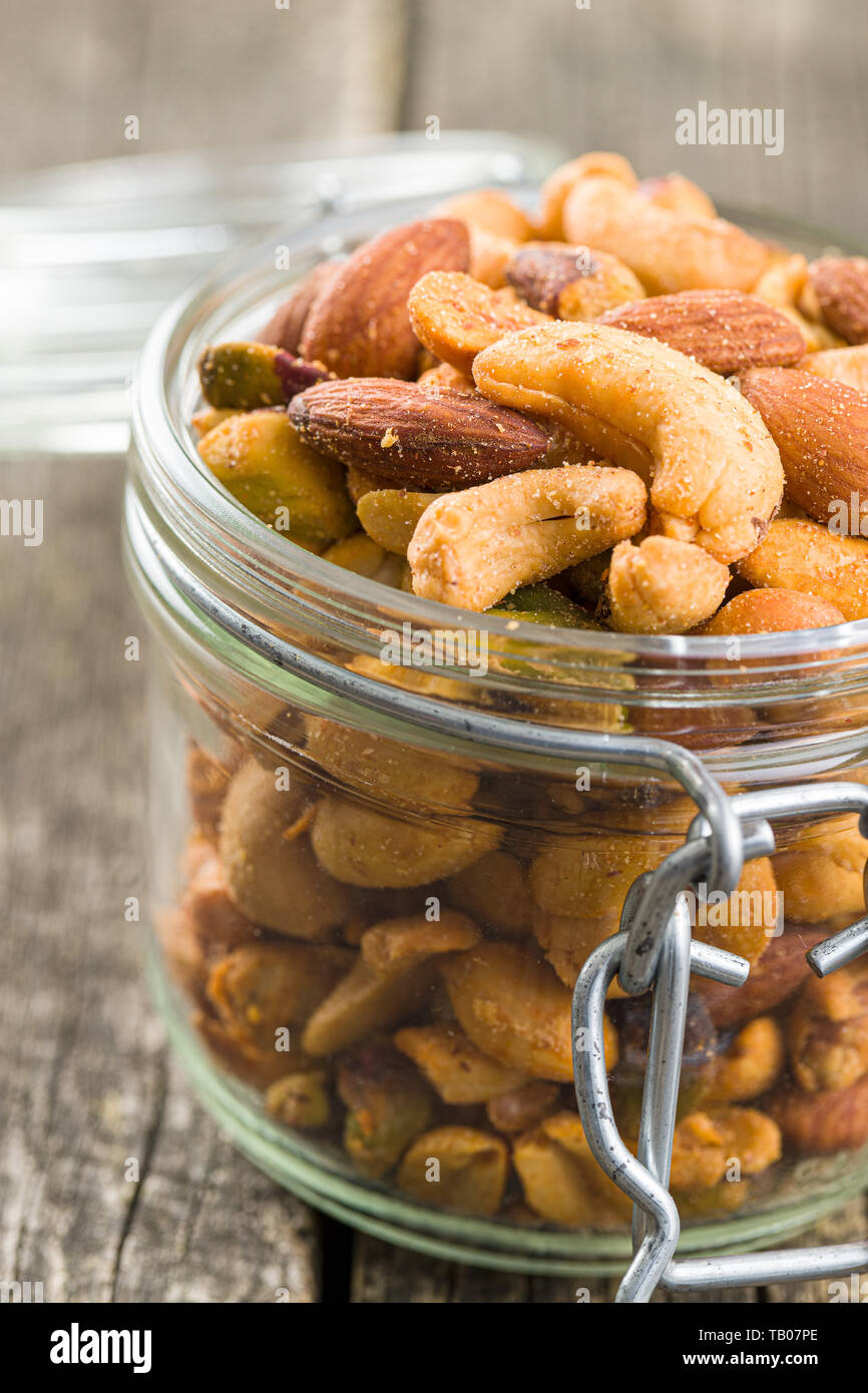 Spicy flavoured nuts. Mix of nuts in jar Stock Photo - Alamy
