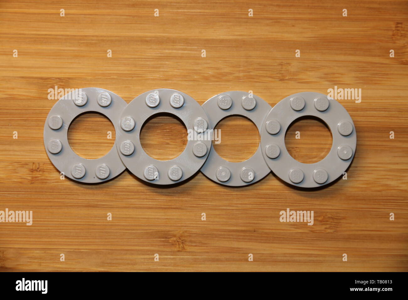 LEGO Audi emblem from light bluish gray plate rings on a wood table ...