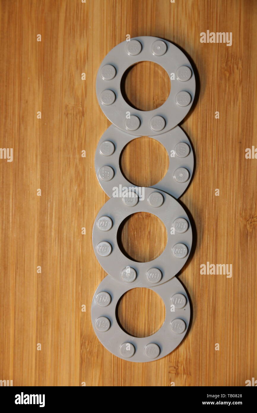 LEGO light bluish gray plate rings together on a wood table Stock Photo ...