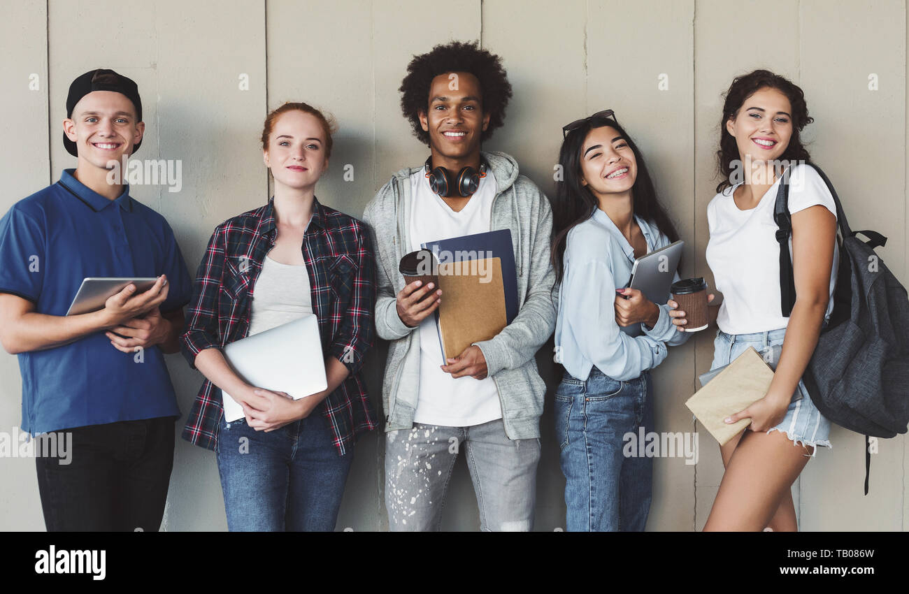 Multiethnic group of cheerful young students standing together Stock Photo - Alamy