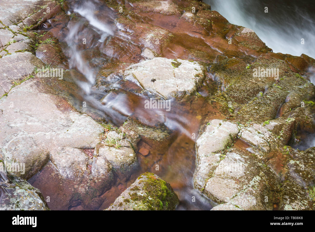 Long exposure view from above of a mountain creak cascading down the ...