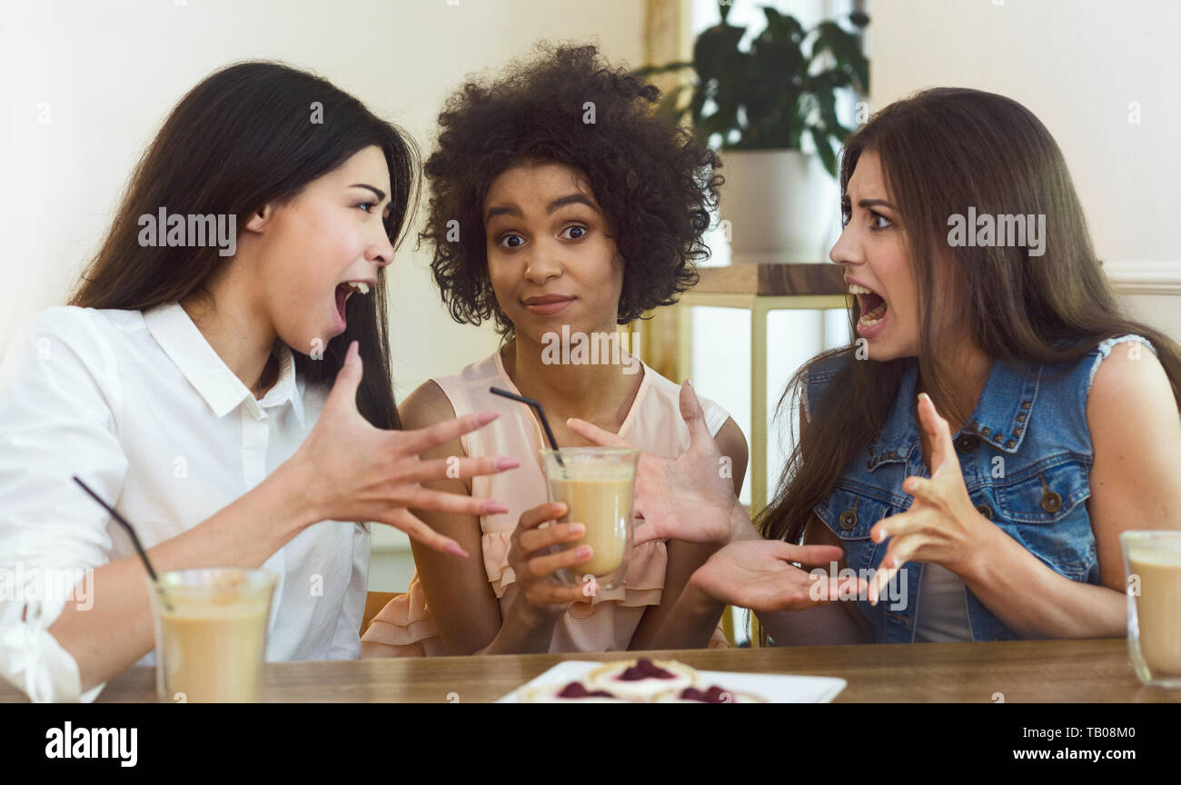 Strange female friendship, women arguing in cafe Stock Photo - Alamy