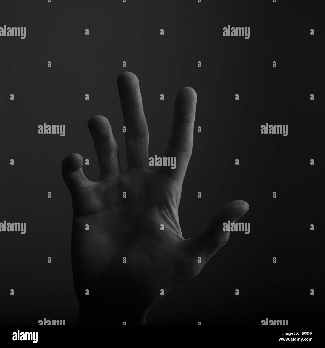 Male open hand gesture on a dark background Stock Photo - Alamy