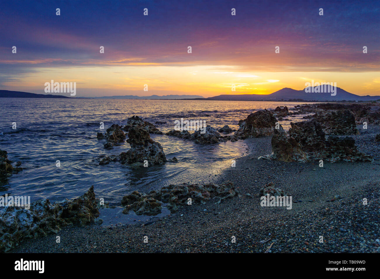 Amazing sunset near Neapolis town, Greece. Rocky seascape scenery with ...
