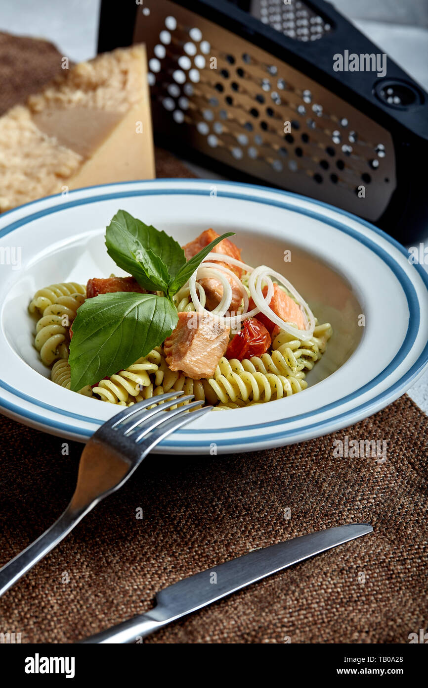 Fusilli pasta with baked salmon and spinach. The concept of Italian ...