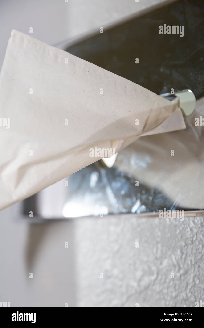 Close up of a tissue dispenser mounted to a wall Stock Photo - Alamy