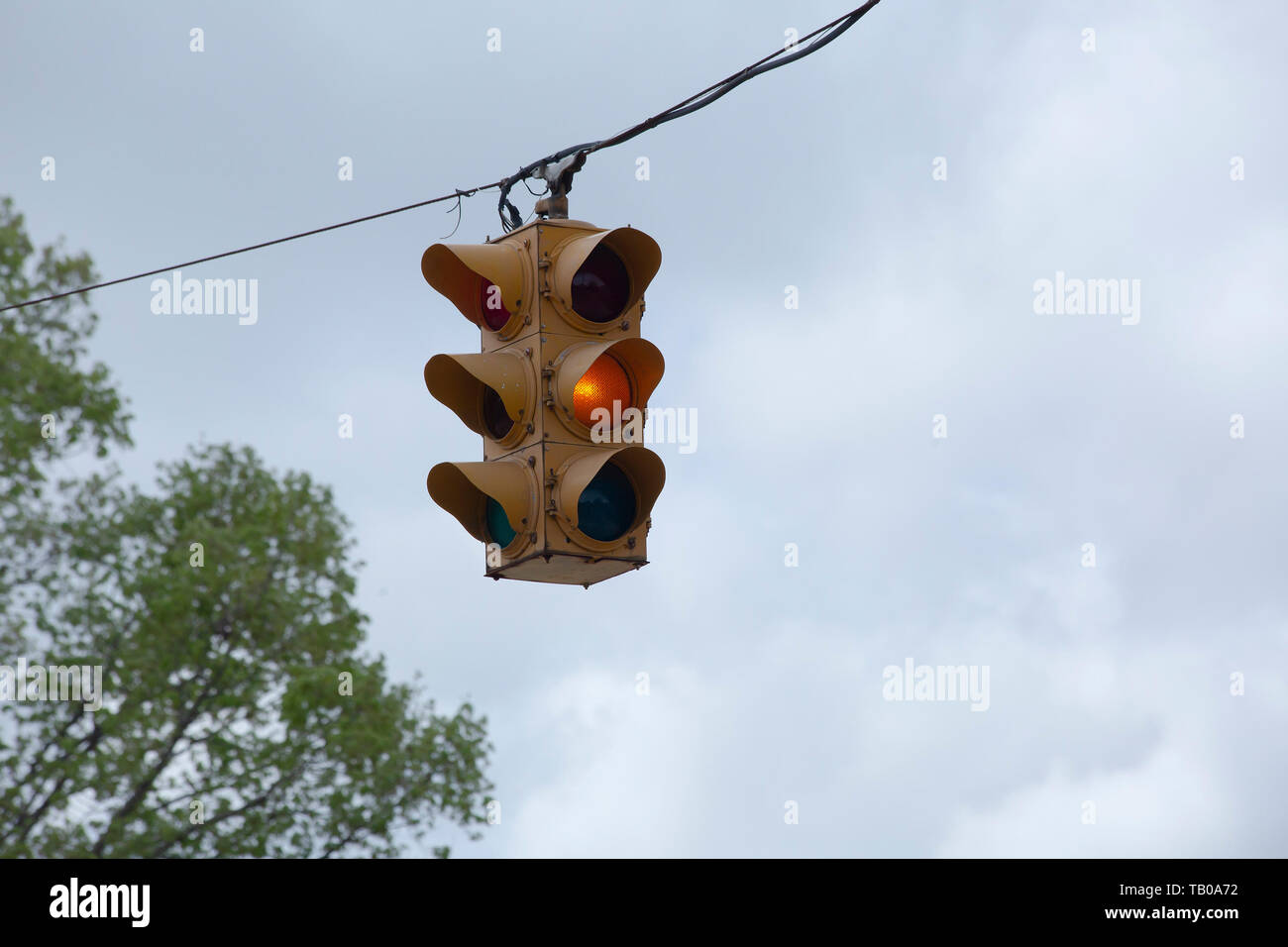 Yellow traffic light signaling for traffic to slow down Stock Photo - Alamy