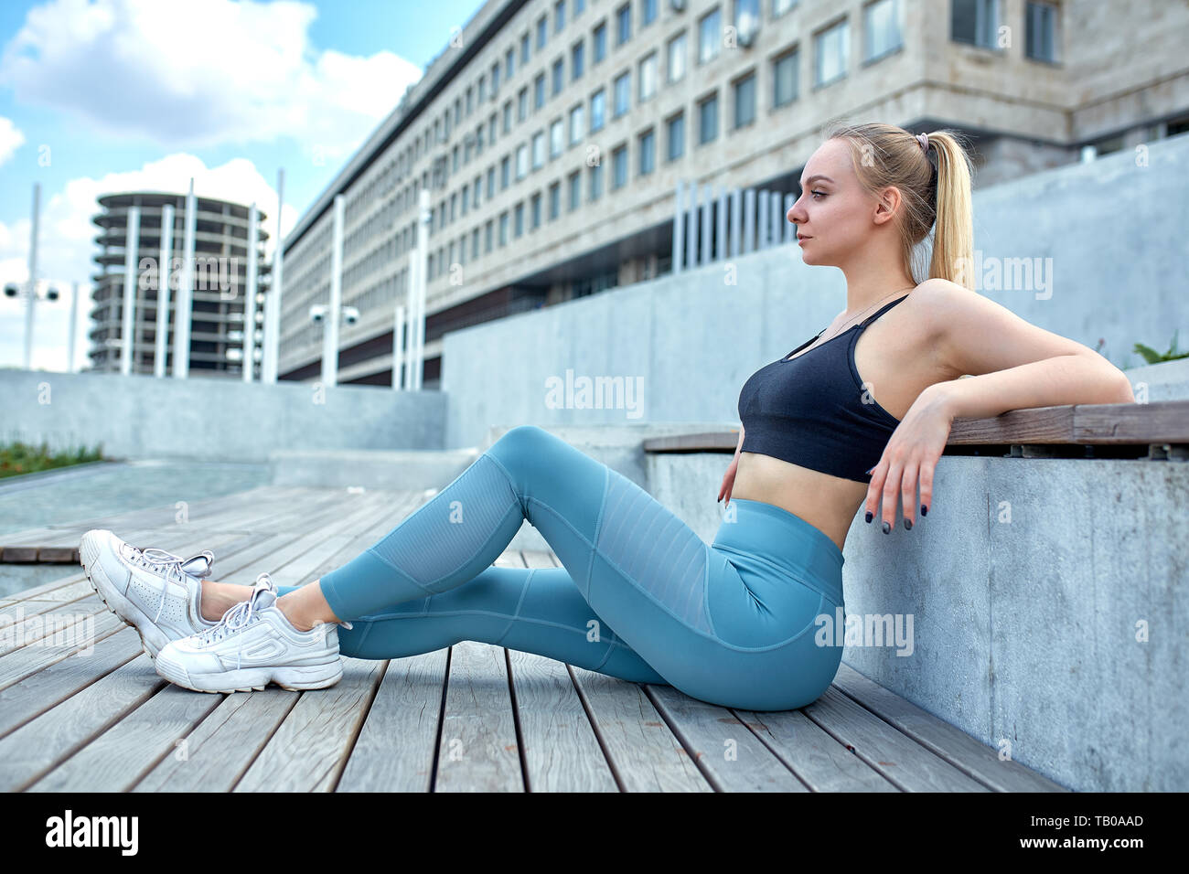 Young European woman sports model posing outdoors along urban ...