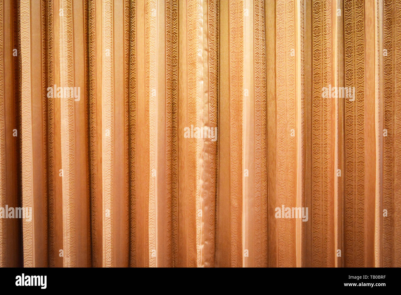 Golden orange fabric curtain texture background Stock Photo - Alamy