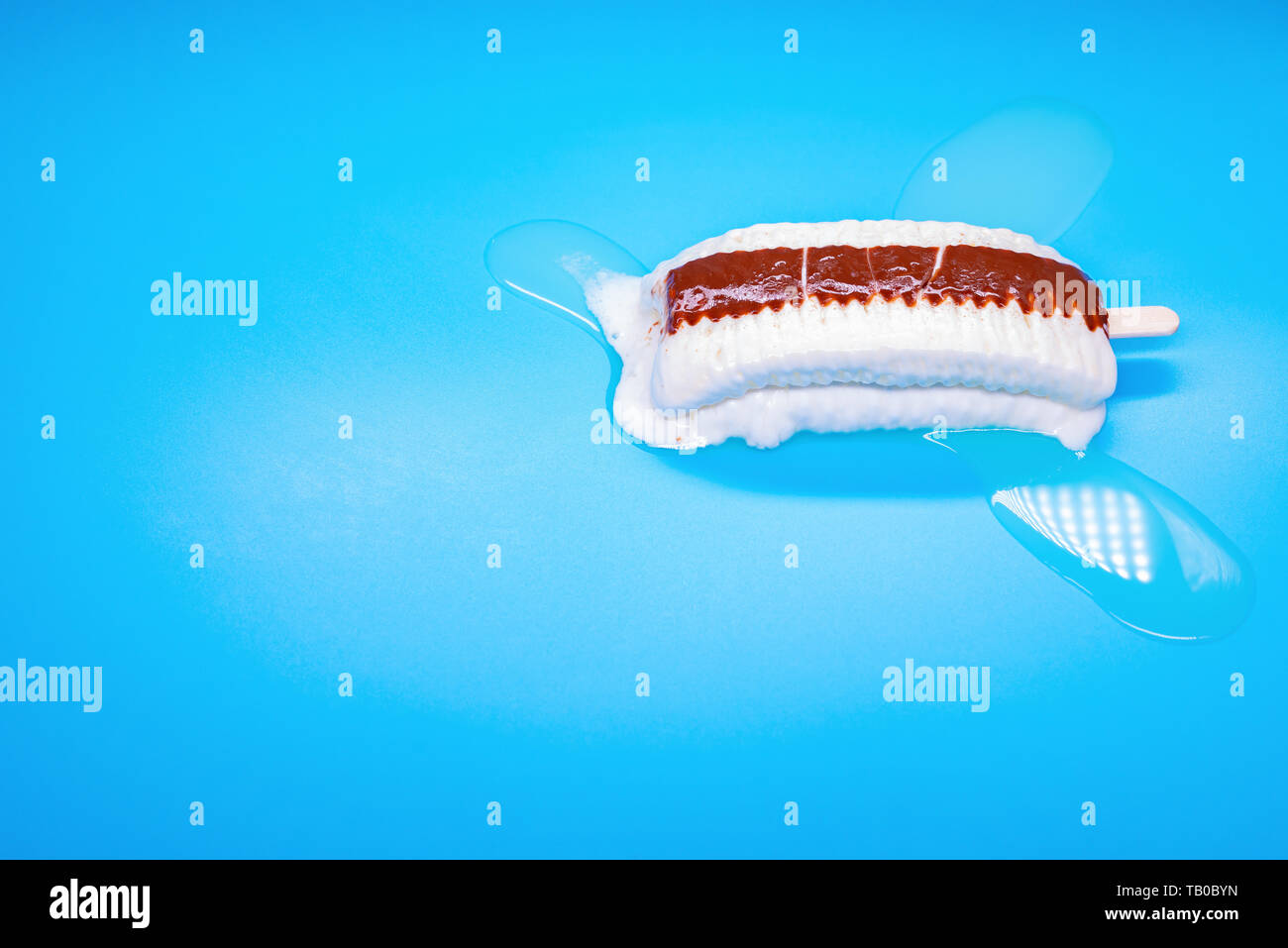 side view chocolate flavor popsicle starts melting on blue background ...