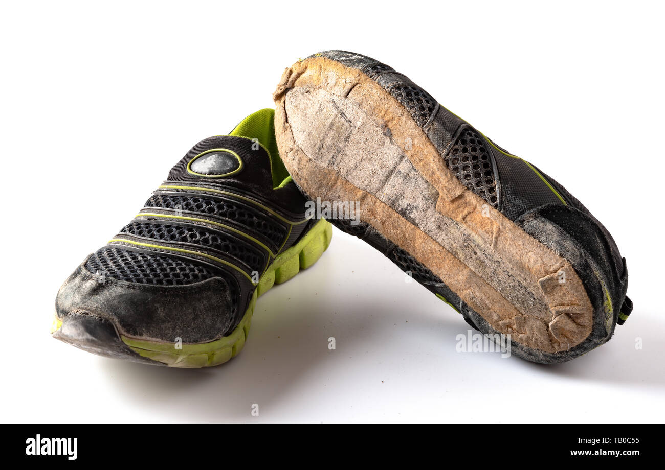 pair of broken sporty shoes on white background Stock Photo - Alamy