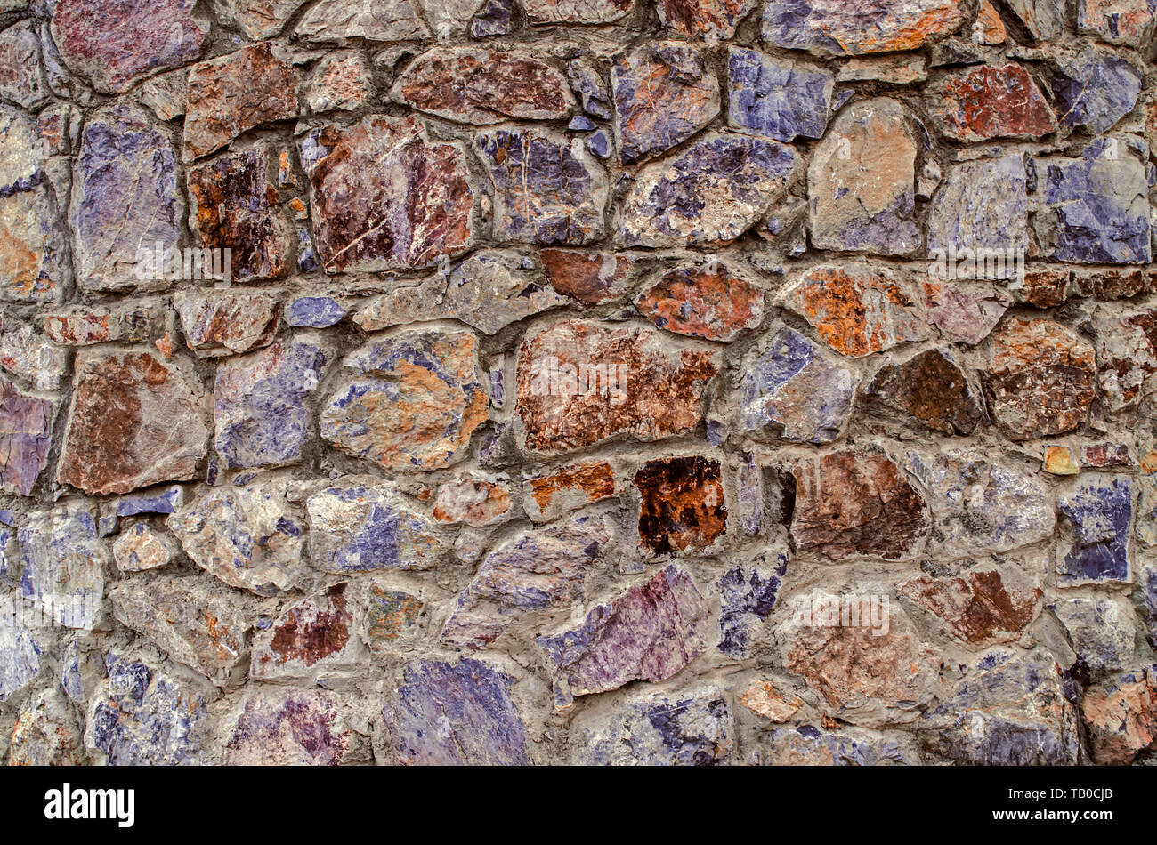 Motley background of stones of different breeds and shades of raw ...