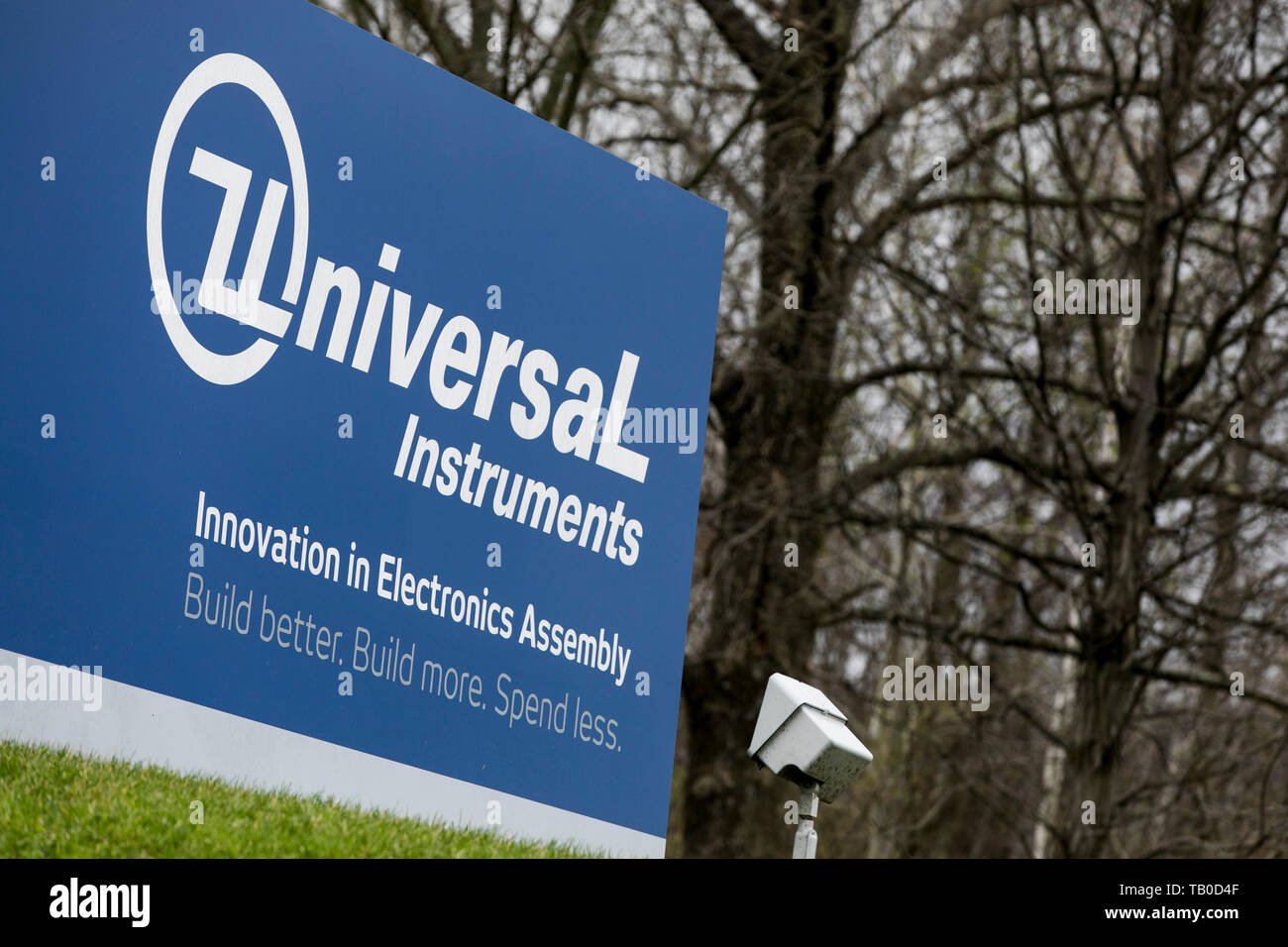 A logo sign outside of the headquarters of Universal Instruments in ...