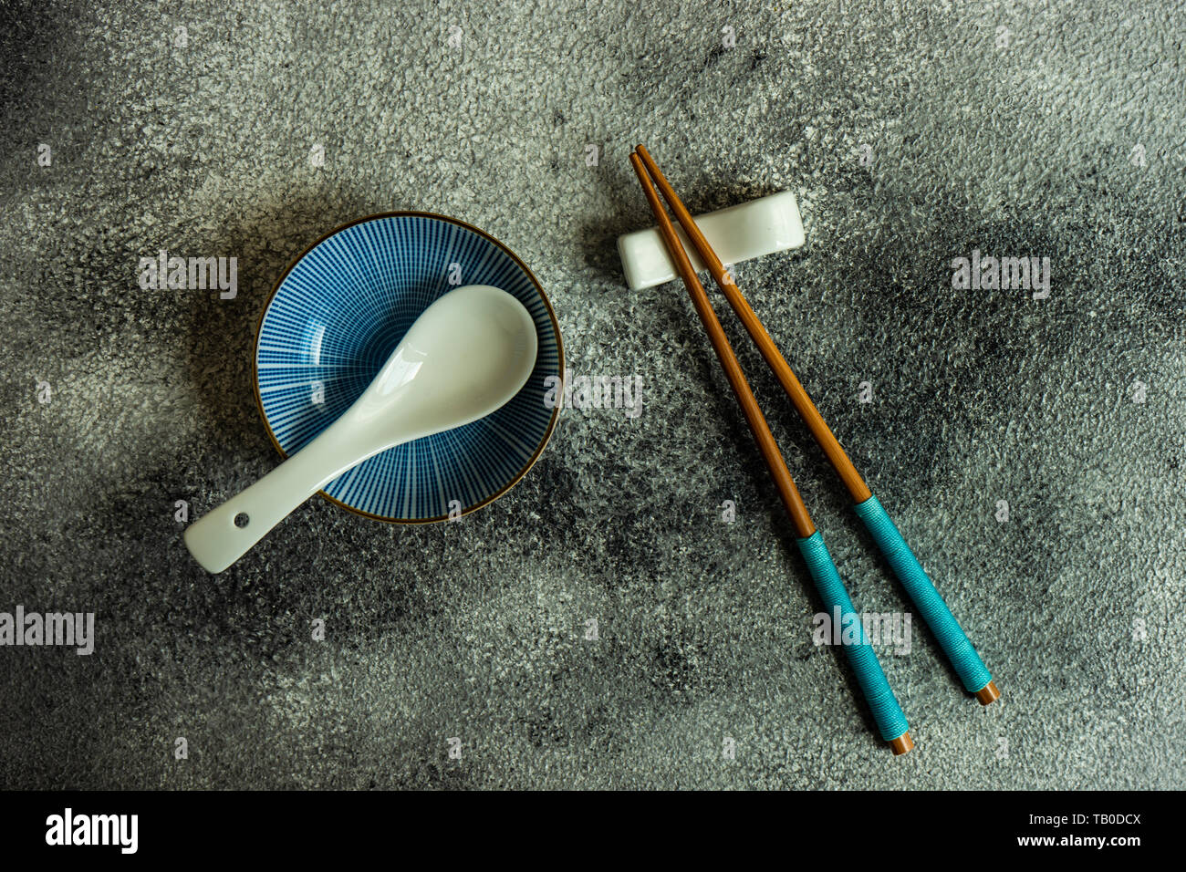 Asian style table setting with chopsticks on grey background with copy ...