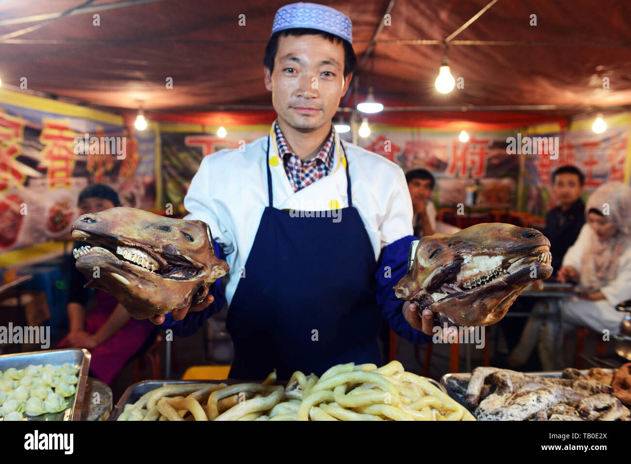 Man holding sheep heads Stock Photo - Alamy