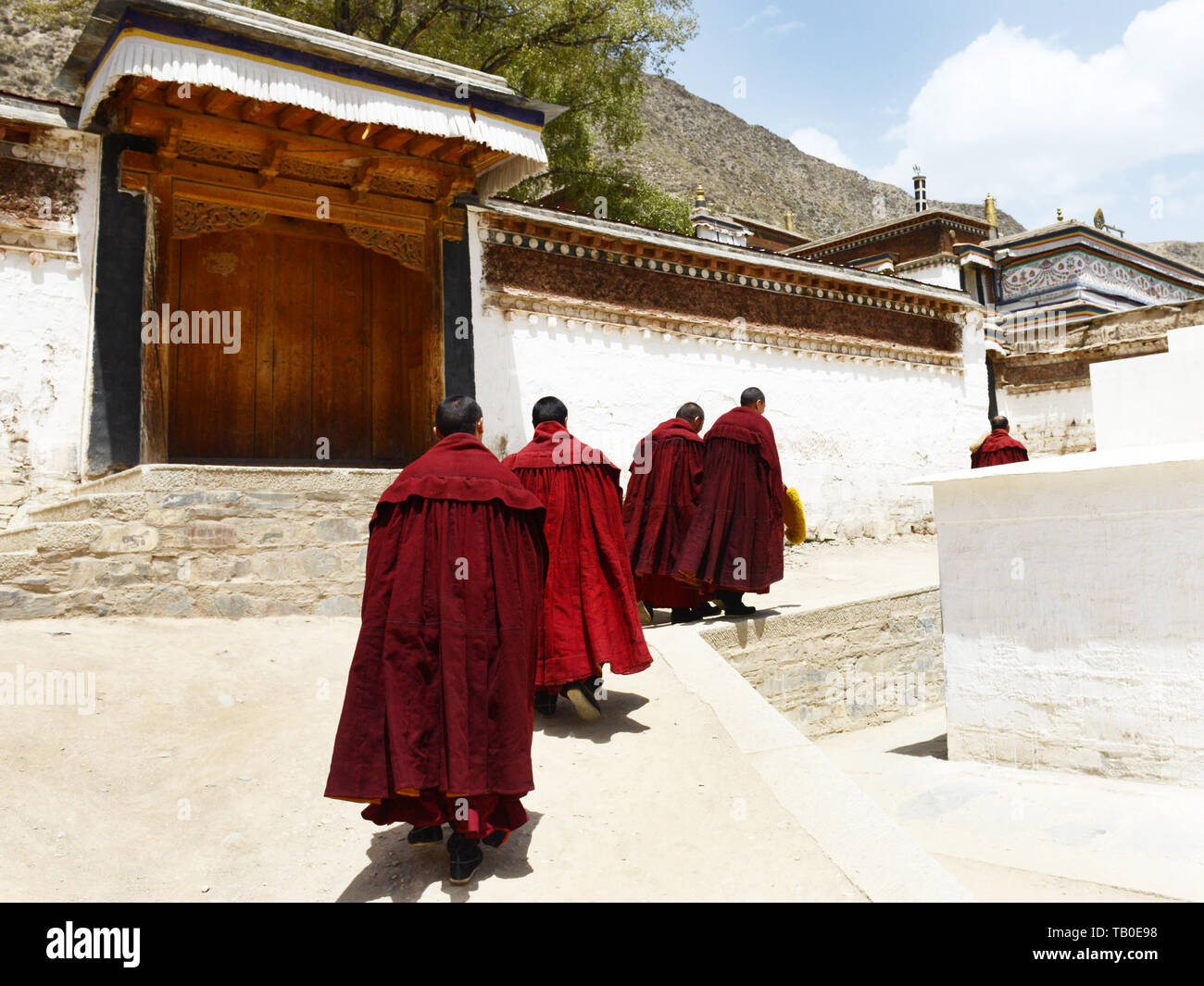 Tibetan monks leaving the main temple after prayers and a ceremony ...
