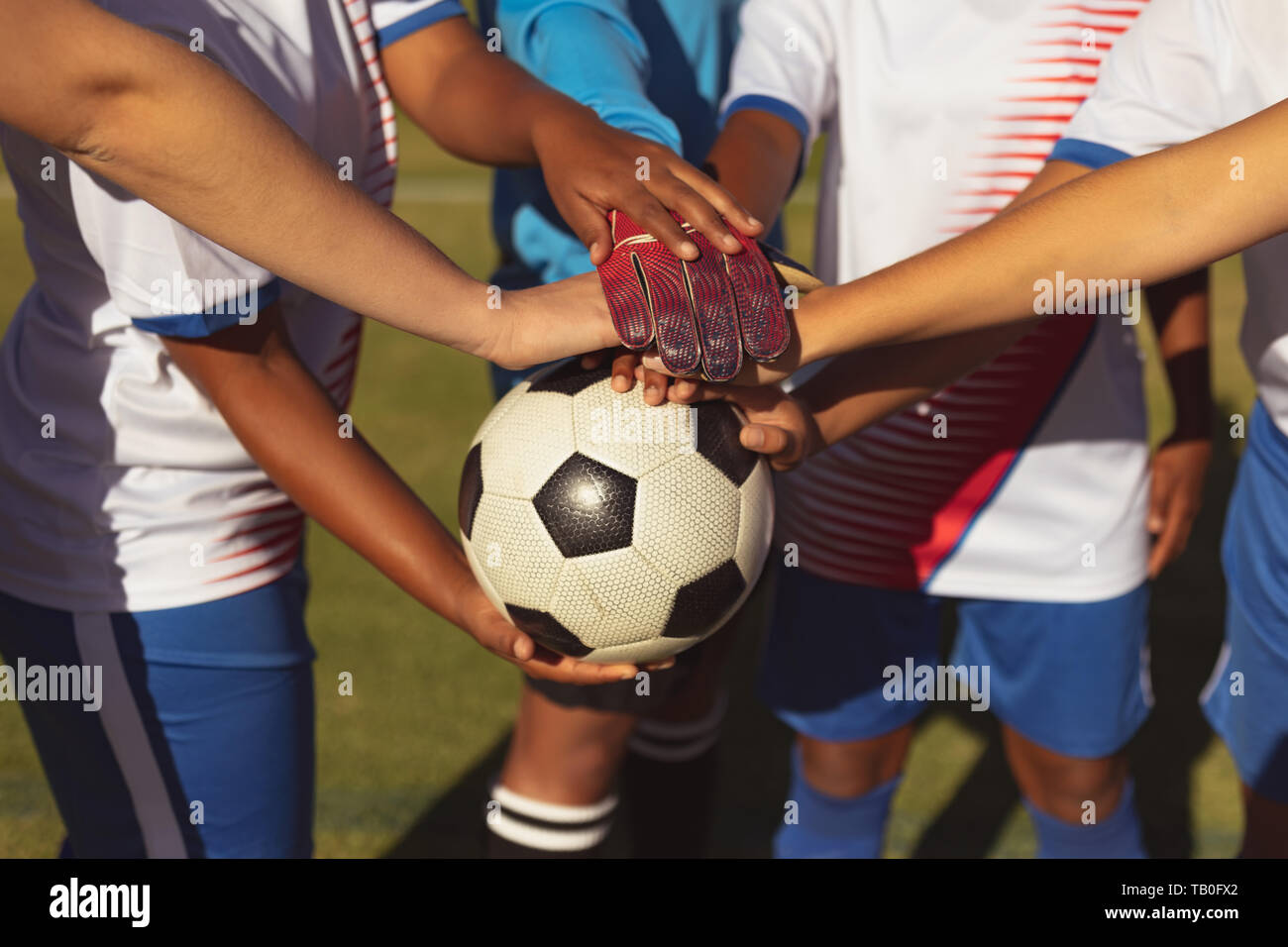 Team of female soccer players forming hand stack at sports field Stock ...