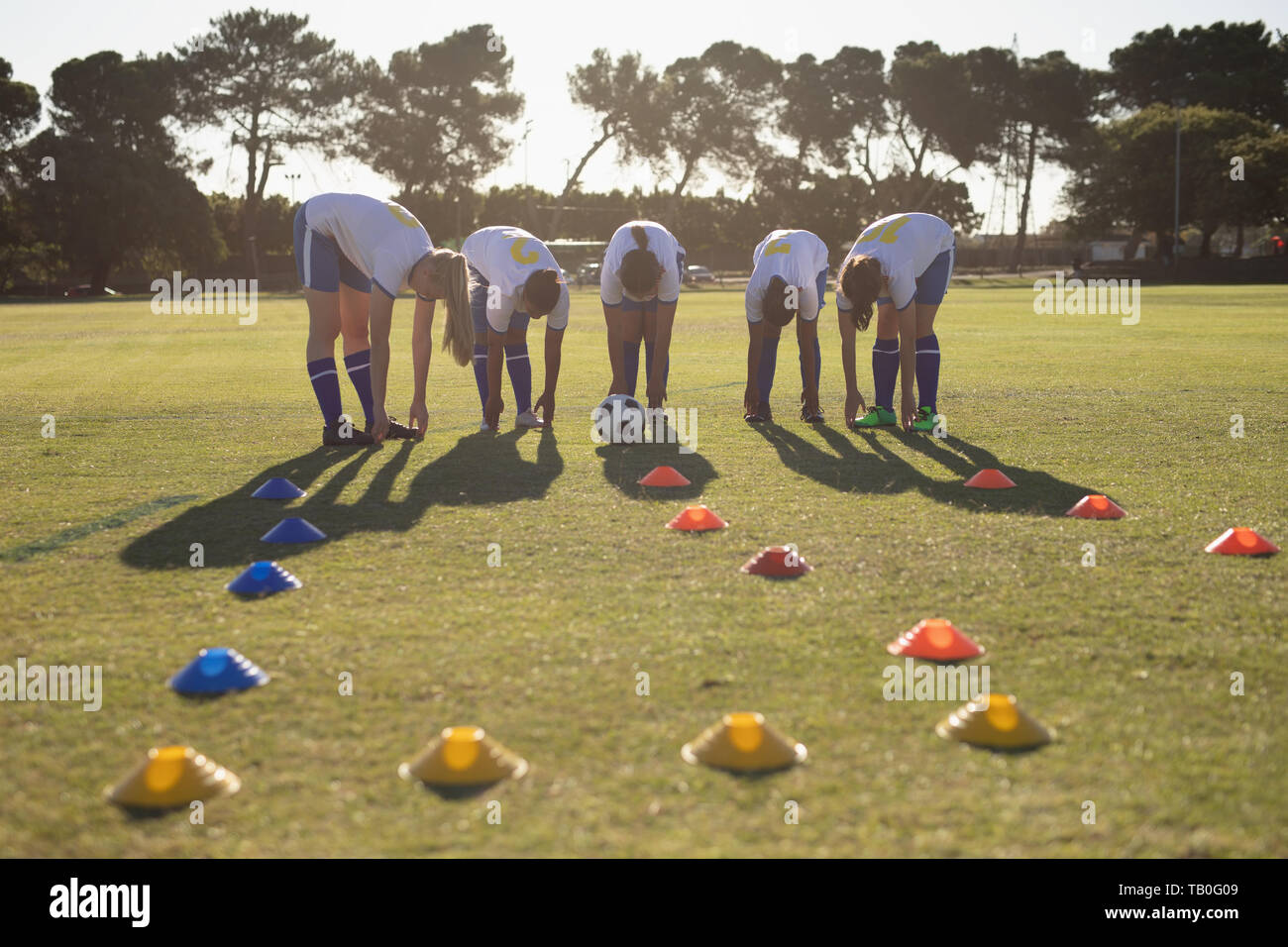 Team of female soccer players doing warm-up exercise on the field Stock ...