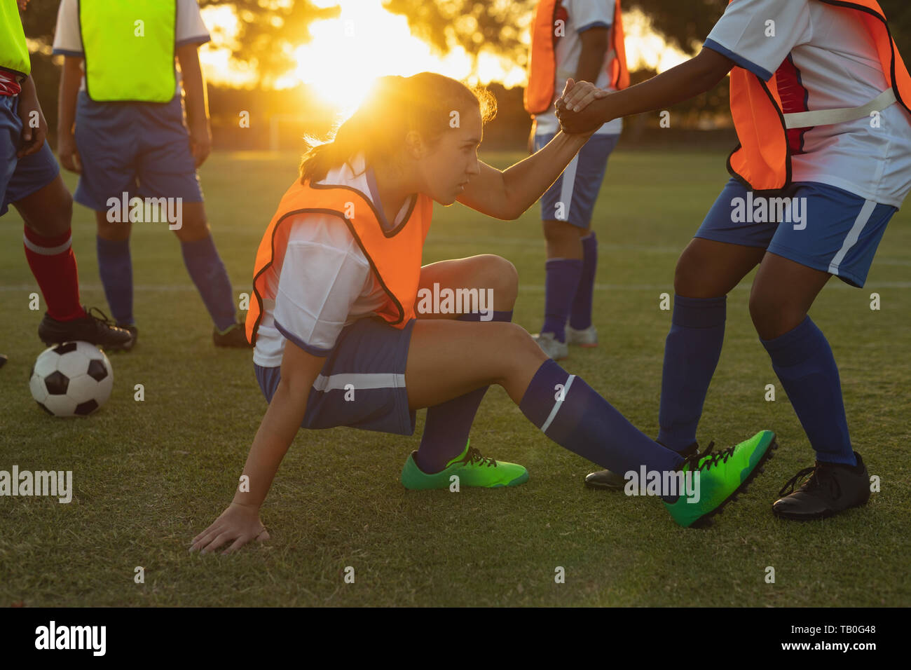 Soccer players doing warm-up exercise at sports field Stock Photo - Alamy