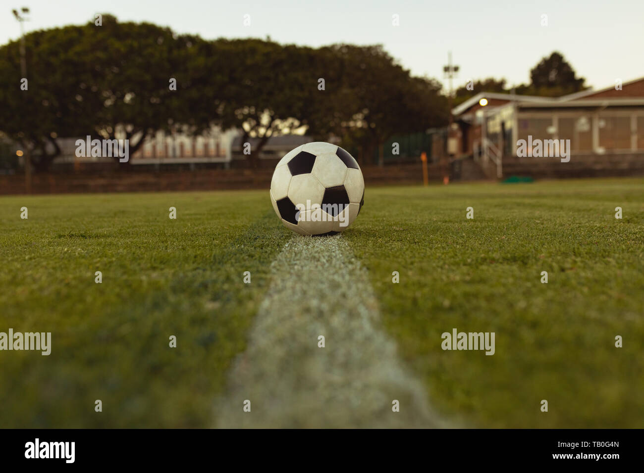 Soccer ball on white line Stock Photo - Alamy