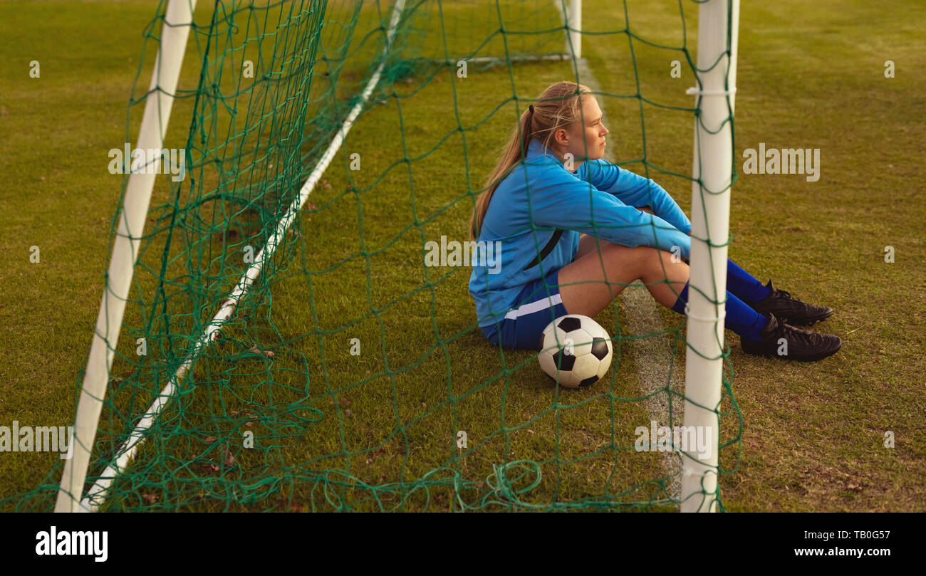 Soccer player relaxing at sports field Stock Photo - Alamy