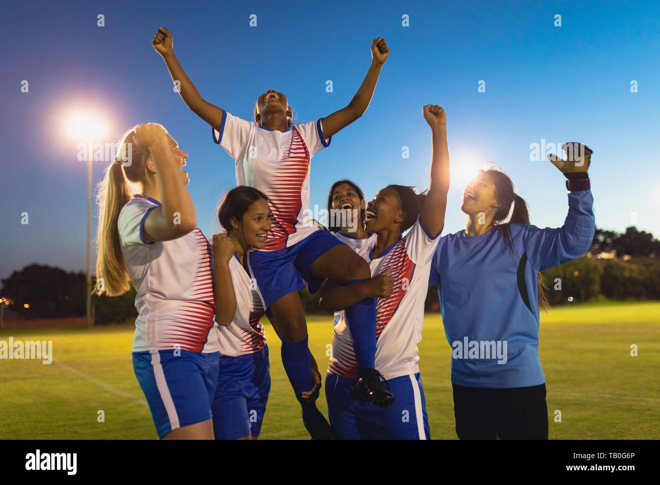 Soccer team cheering on their victory Stock Photo - Alamy