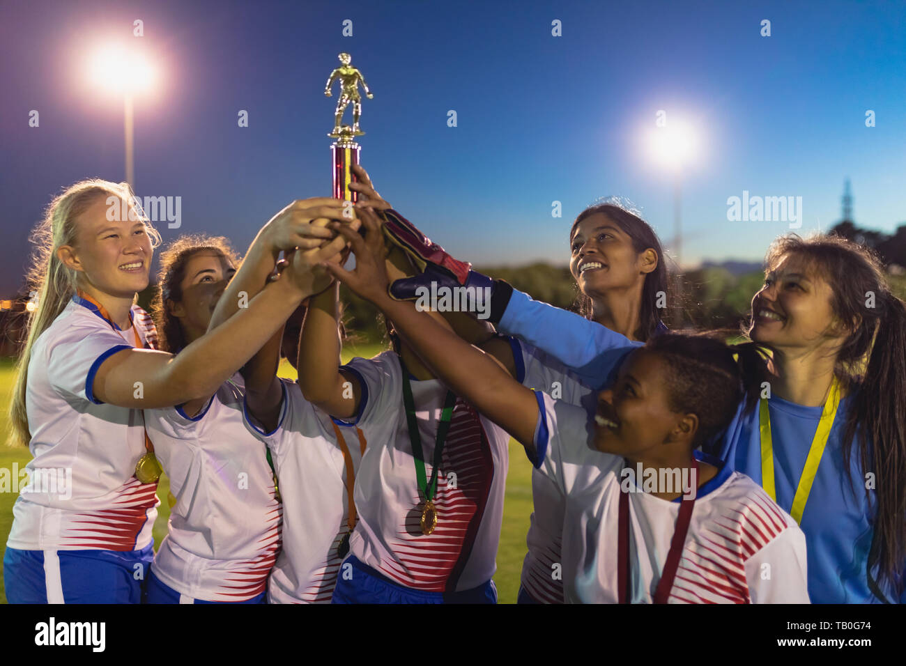 Winner team holding trophy Stock Photo - Alamy