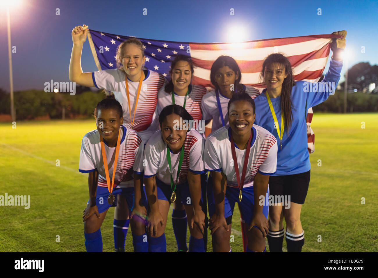 Soccer team posing with American flag Stock Photo - Alamy